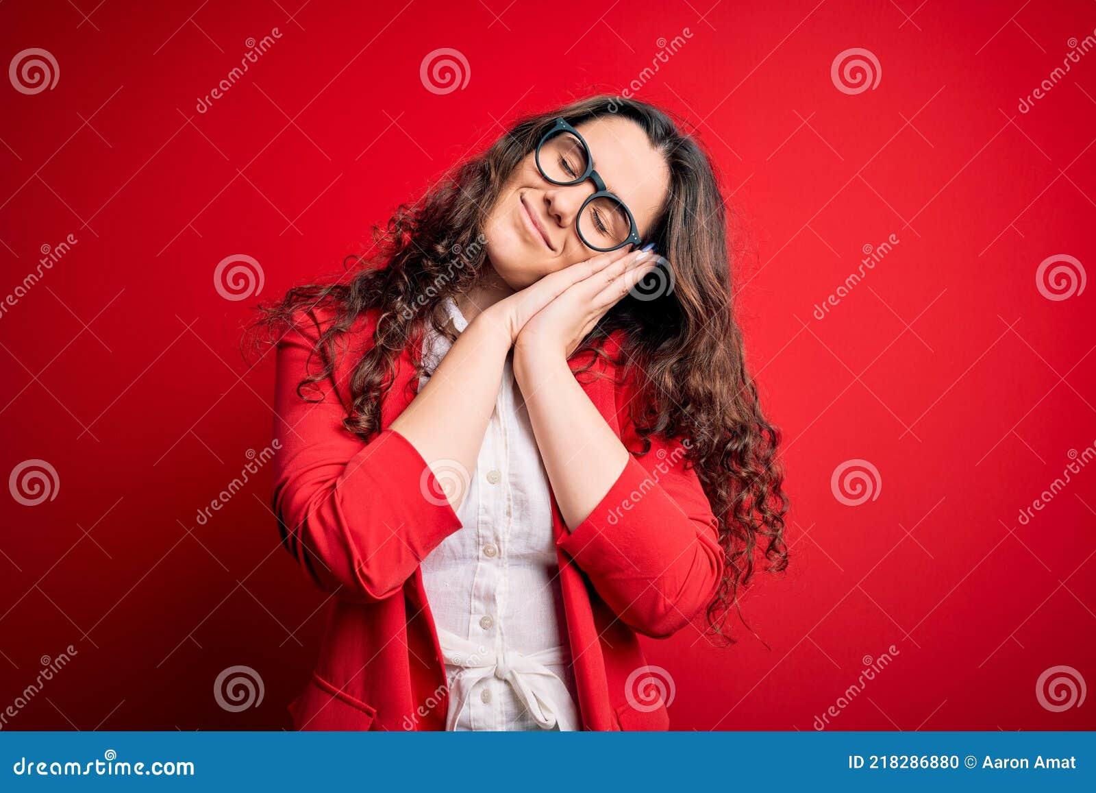 Young Beautiful Woman With Curly Hair Wearing Jacket And Glasses Over