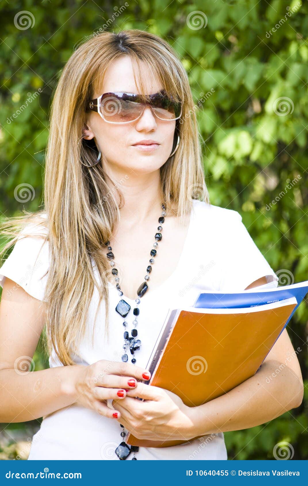 Young Beautiful Woman Holding Books Stock Image - Image of green, books ...