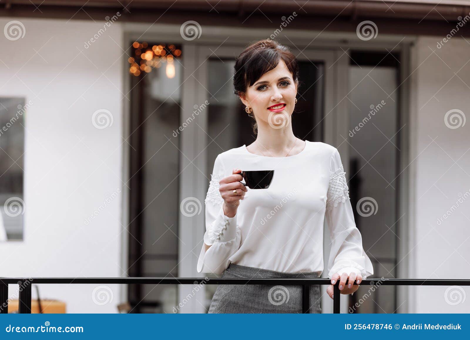 Young Beautiful Woman Holding A Cup Of Coffee Or Tea In Cafe