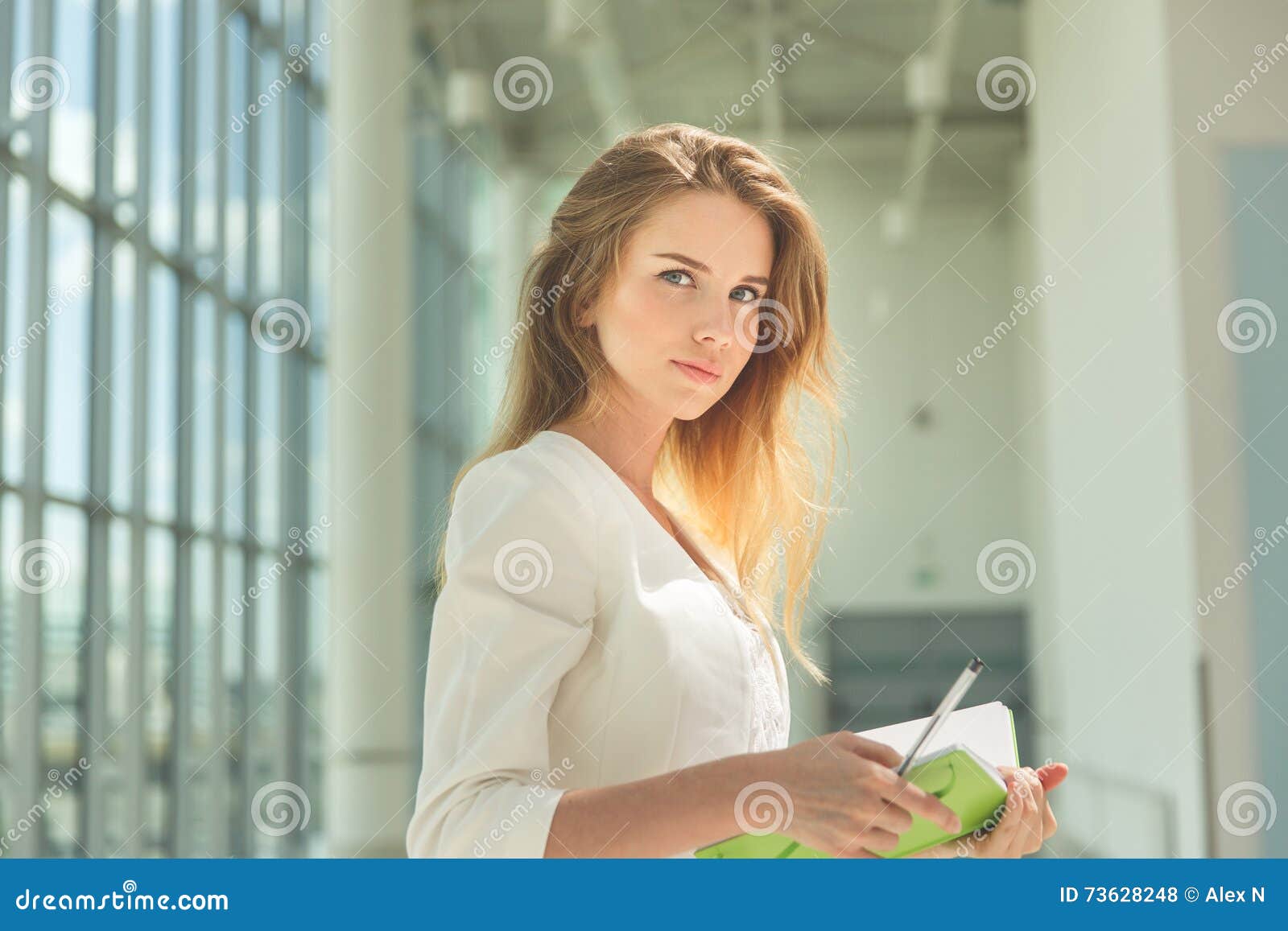 Young Beautiful Woman Holding Green Notebook. Stock Photo - Image of ...