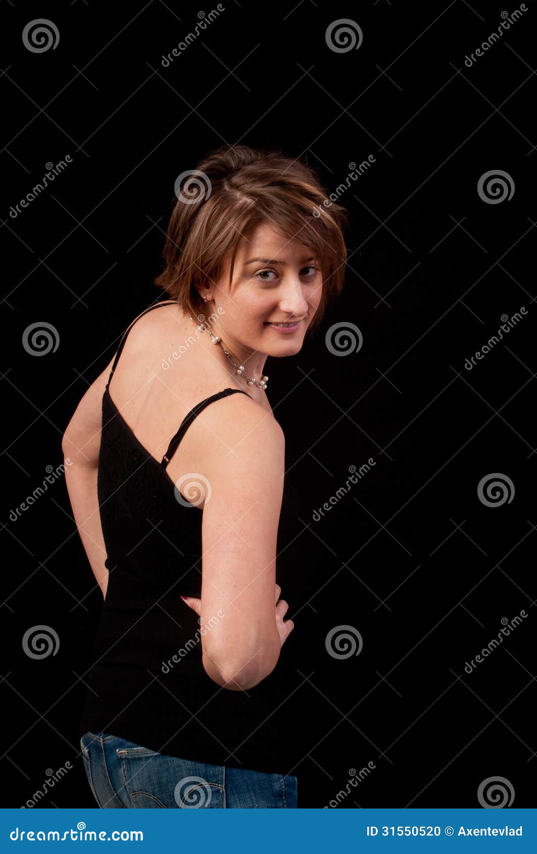 Young Beautiful Woman Posing and Looking Over Her Shoulder on Bl Stock ...