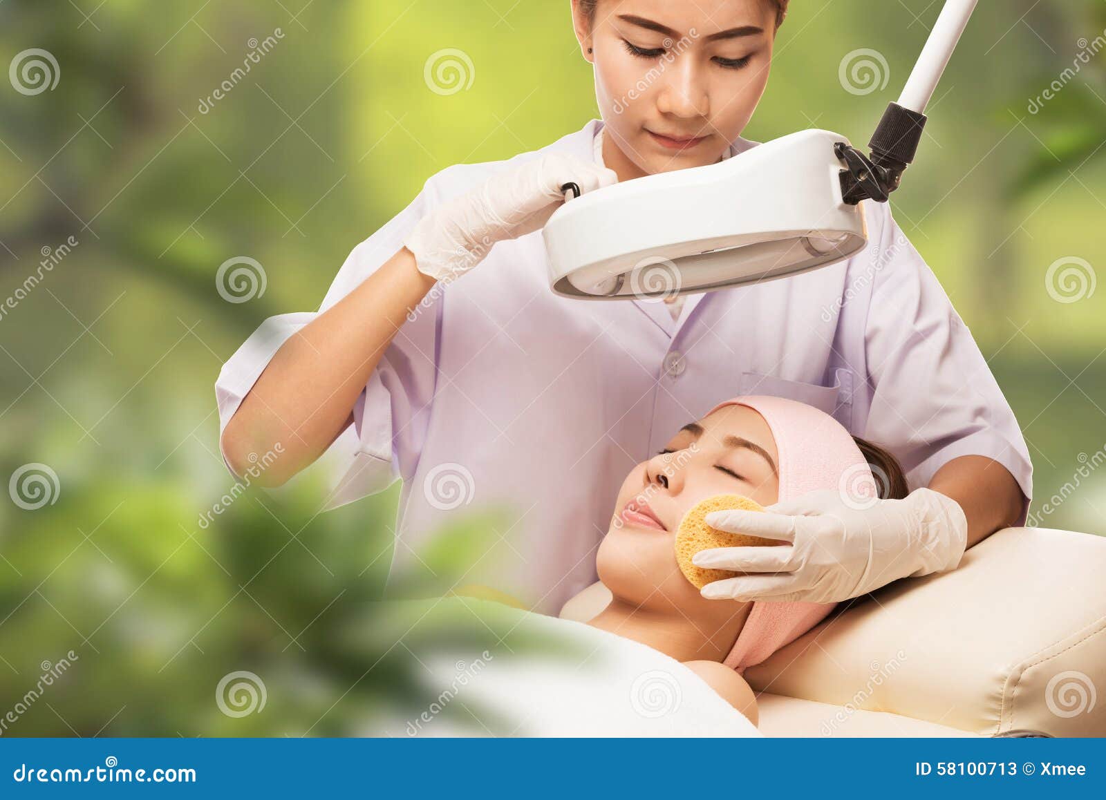 Young Beautiful Woman Receiving Cosmetic Facial Mask In Spa Beauty