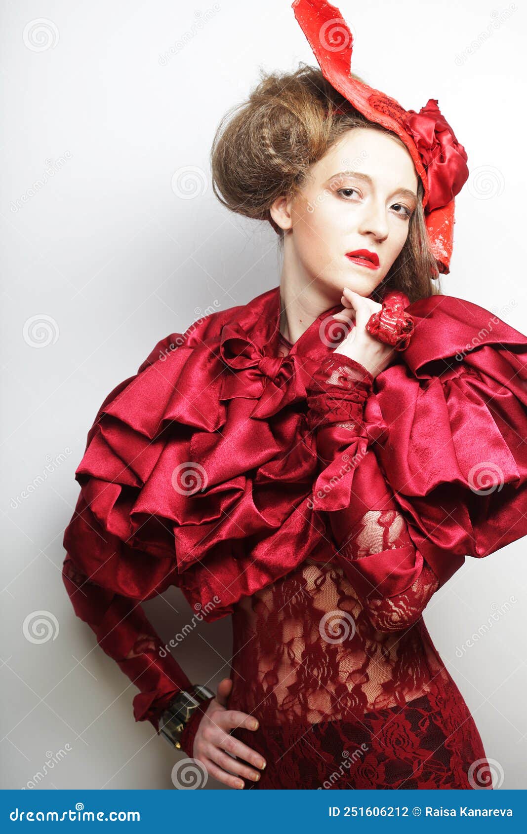 Young Beautiful Woman In A Red Lace Suit And Hat A Stylish Blonde In