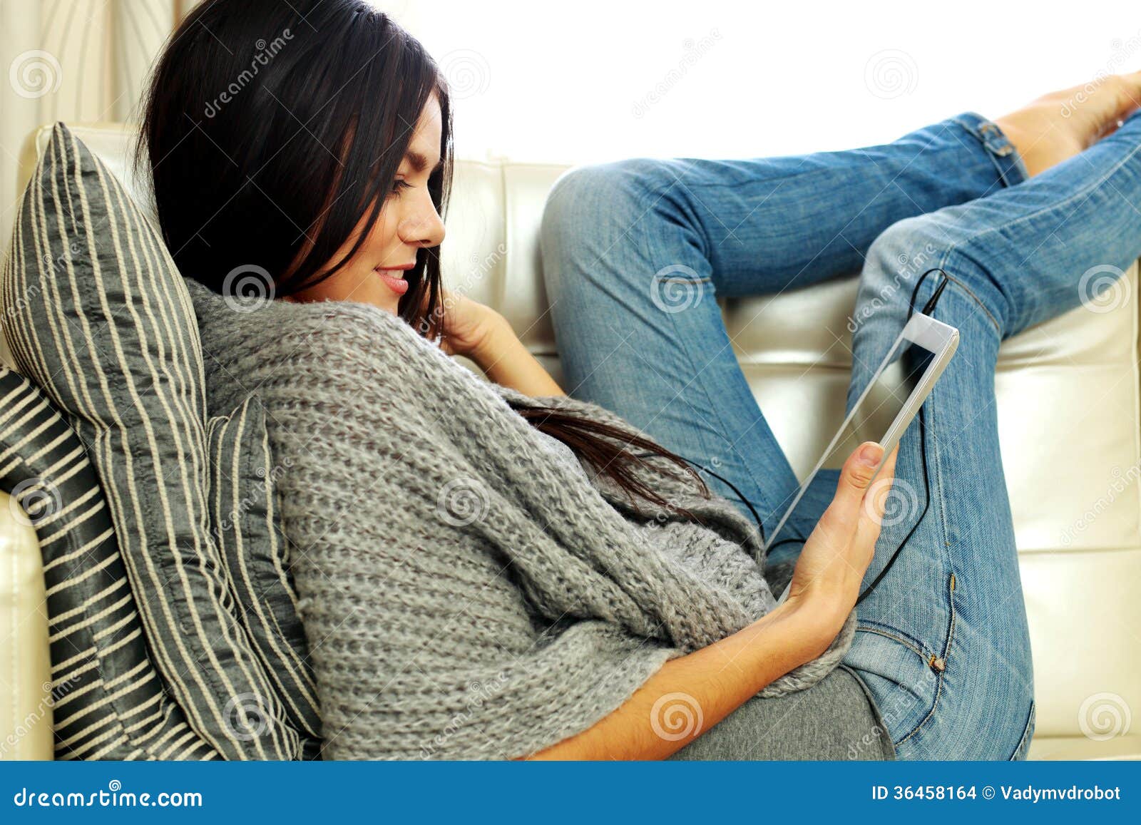 Young Beautiful Woman Resting on a Sofa with Tablet Computer Stock ...