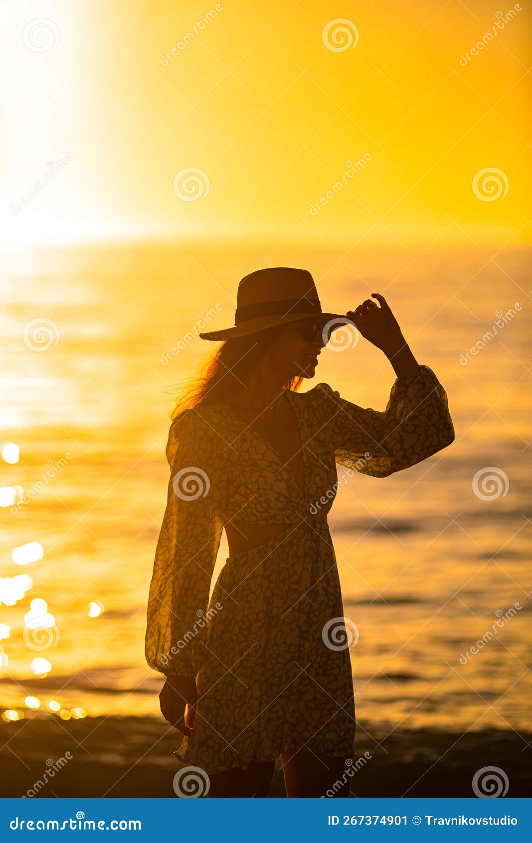 Young Beautiful Woman At Straw Hat On The Beach At Sunset Stock Image