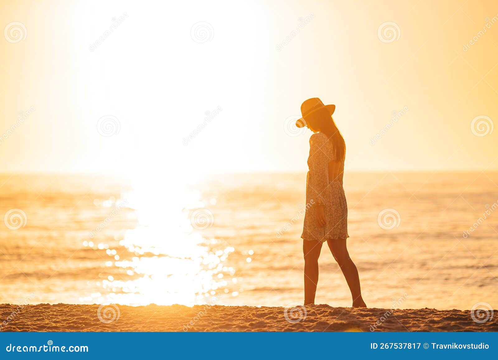 Young Beautiful Woman At Straw Hat On The Beach At Sunset Stock Image