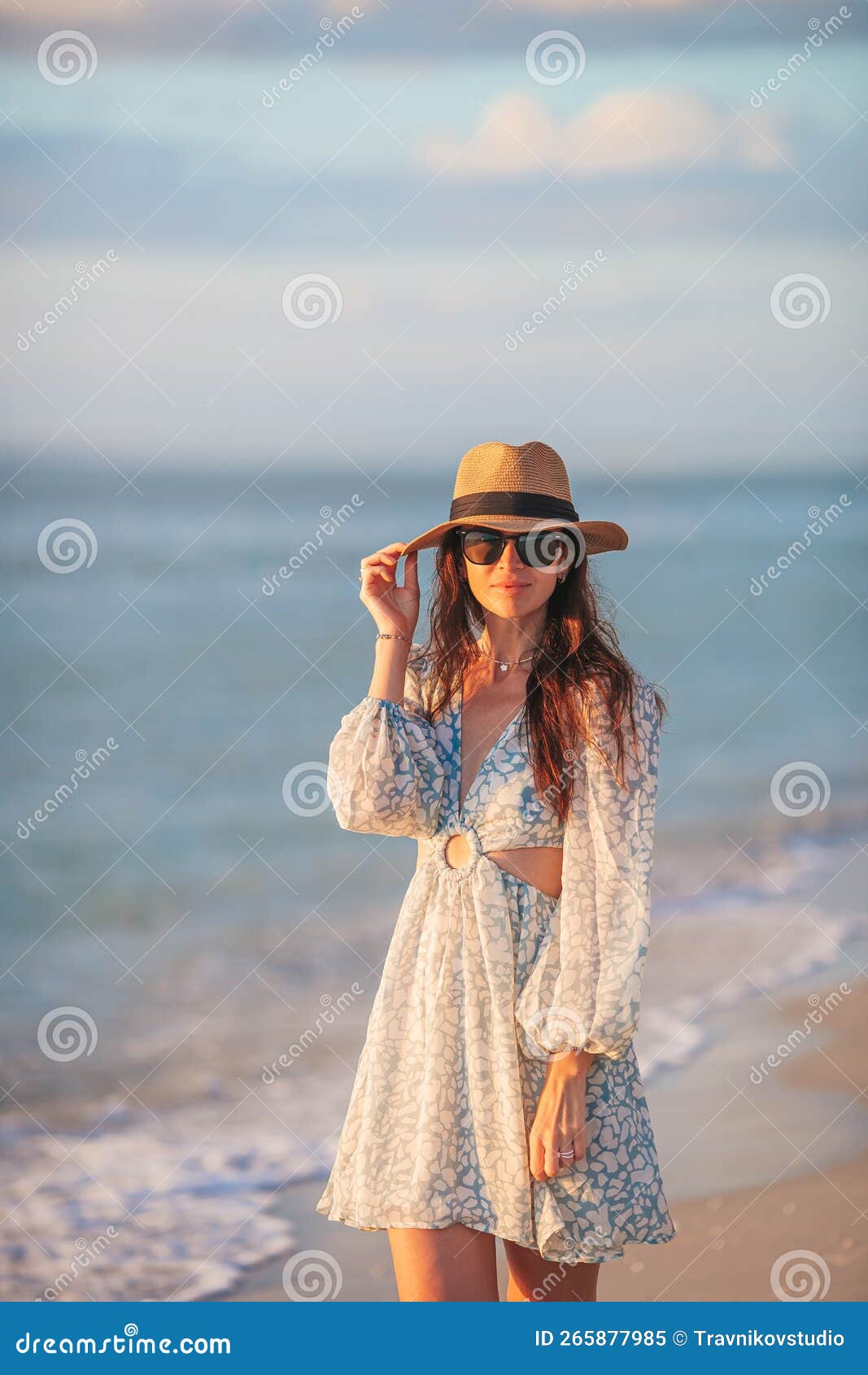 Young Beautiful Woman At Straw Hat On The Beach At Sunset Stock Image