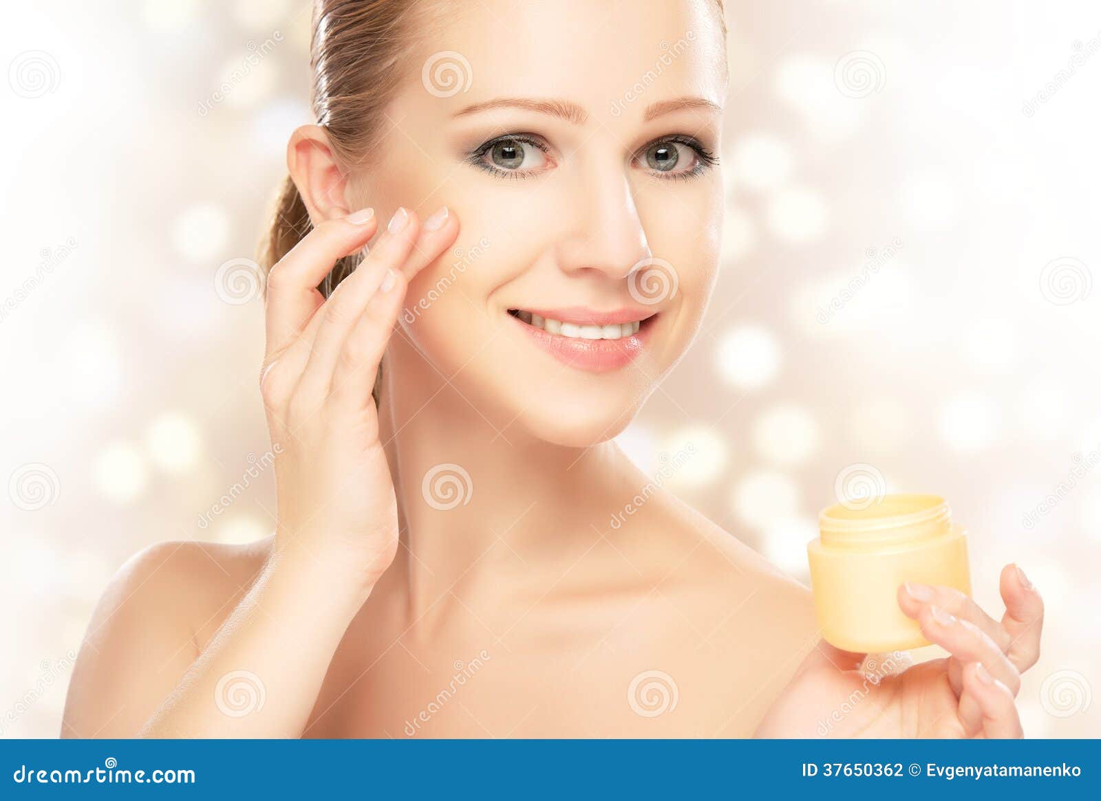 Young Beautiful Woman Using a Face Cream Stock Photo - Image of ...