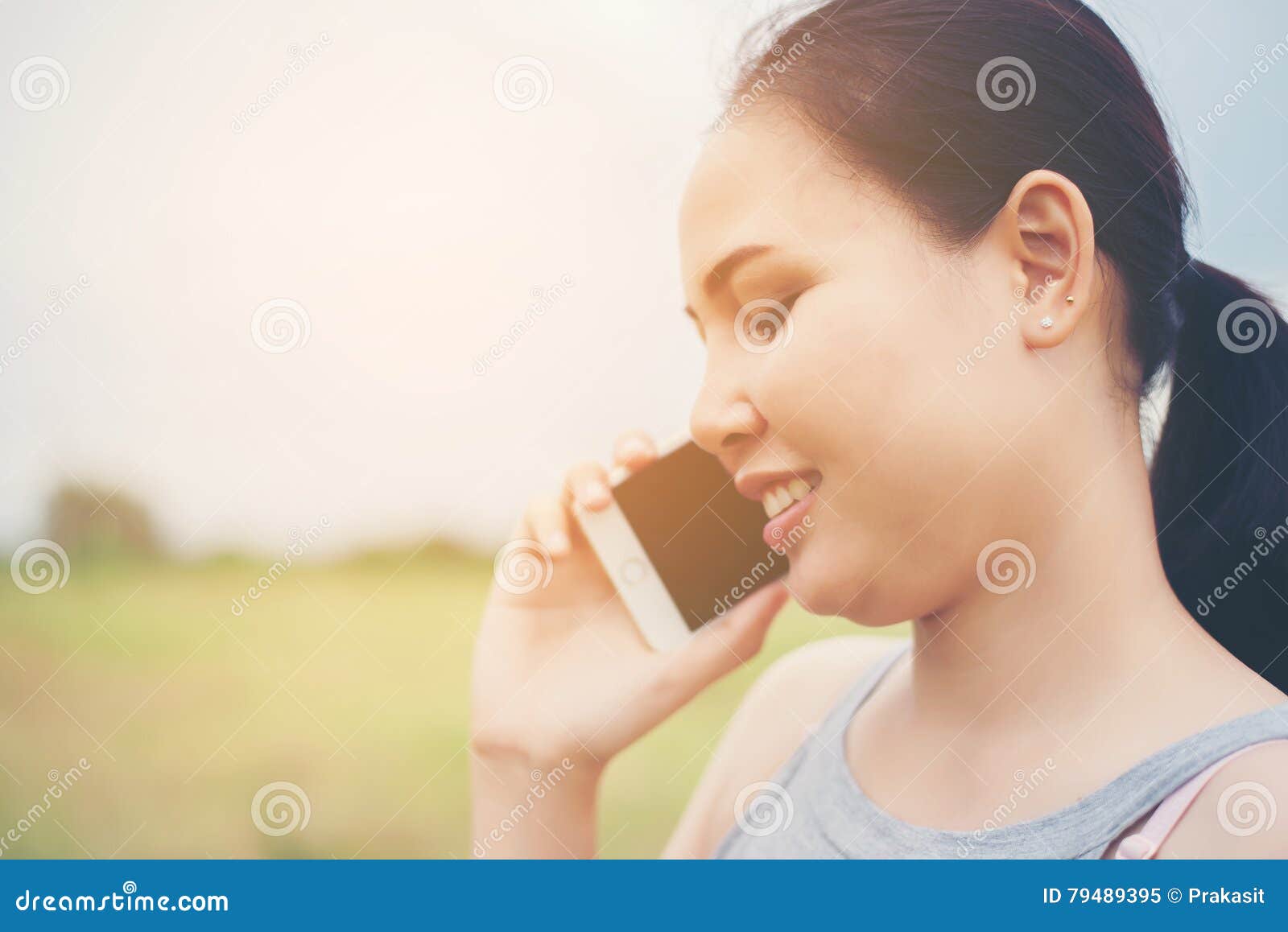 Young Beautiful Woman Using Smartphone and Smiling in the Park. Stock ...