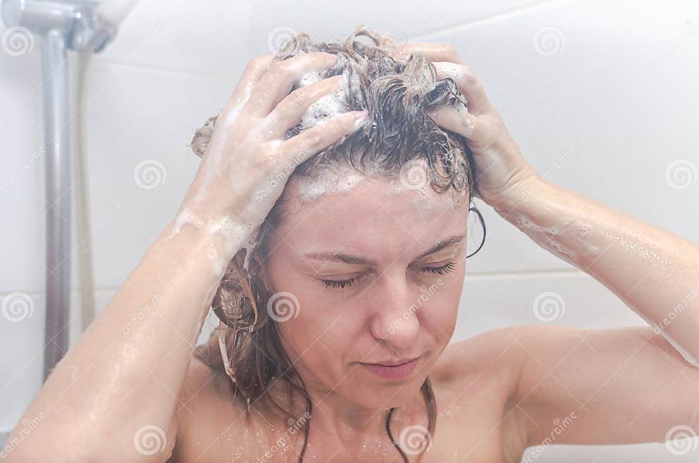 Young Beautiful Woman Washing Her Hair With Shampoo In The Shower Stock