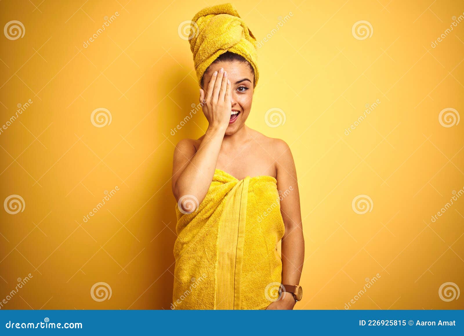 Young Beautiful Woman Wearing Towel After Shower Over Isolated Yellow