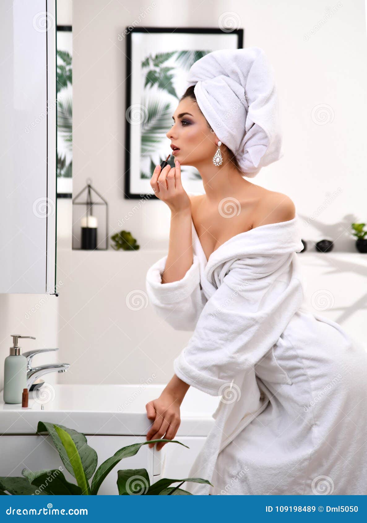 Young Beautiful Woman With White Towel On Head Do Makeup Looking At The