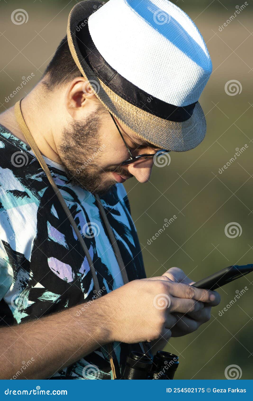Young Bird Watcher Identifies a Bird in the Field Using a Cell Phone ...