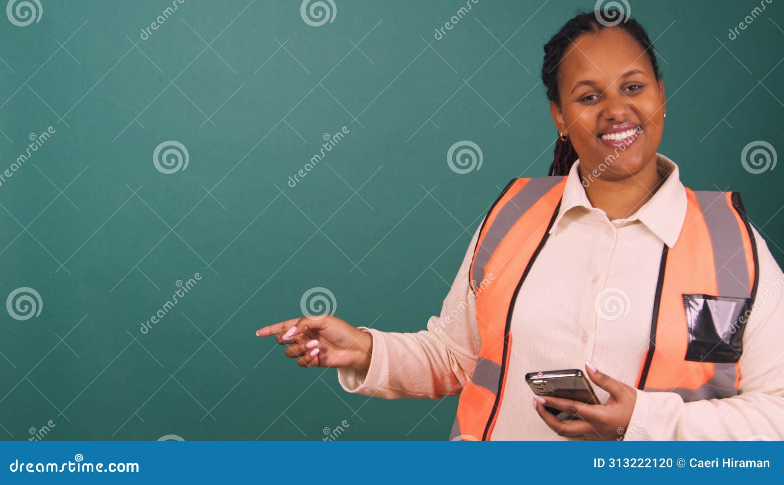 Young Black Construction Worker Points To Copy Space Smiling, Working ...