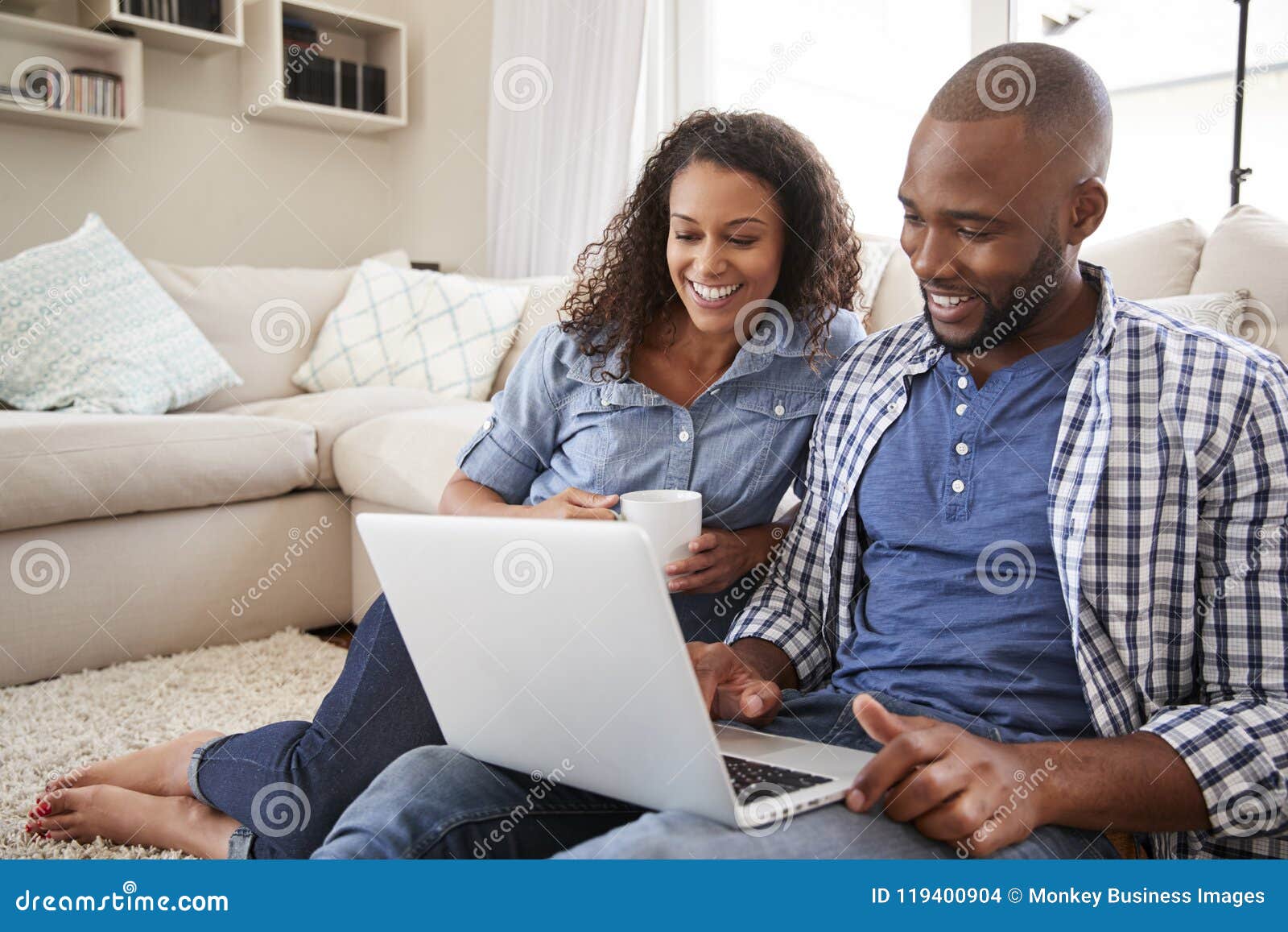 Young Black Couple Using Laptop Sitting on the Floor at Home Stock ...