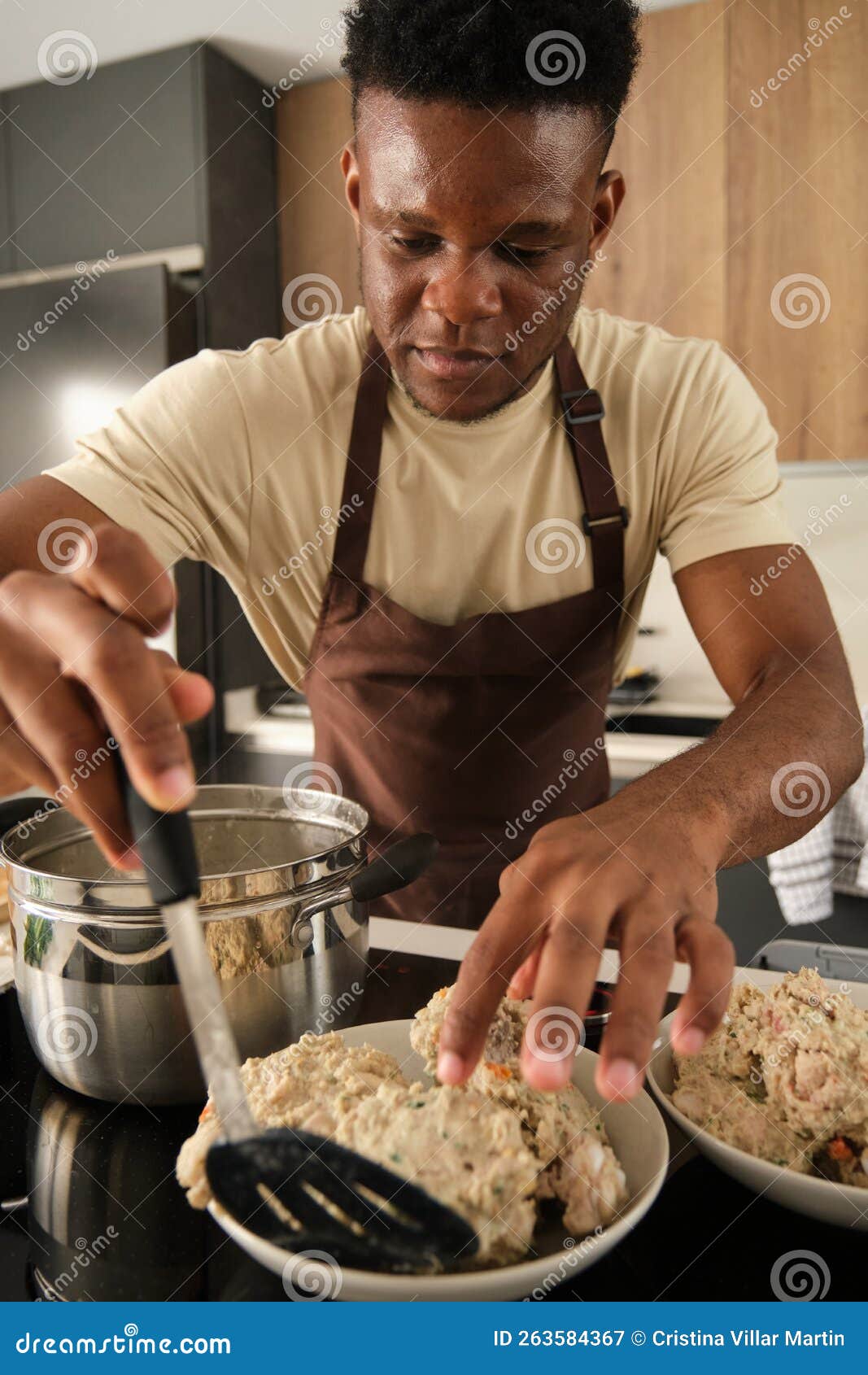 Young Black Man Preparing Boiled Chicken Mince with Vegetables Recipe ...