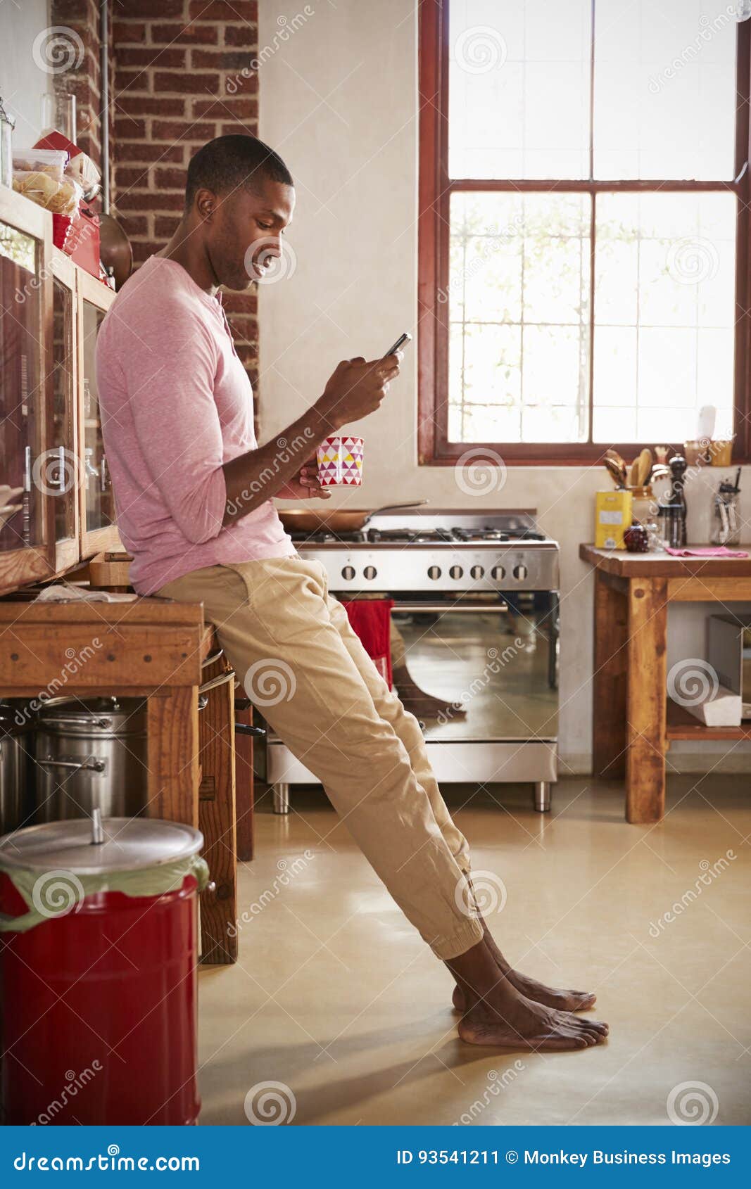 Young Black Man Using Smartphone in Kitchen, Full Length Stock Image ...