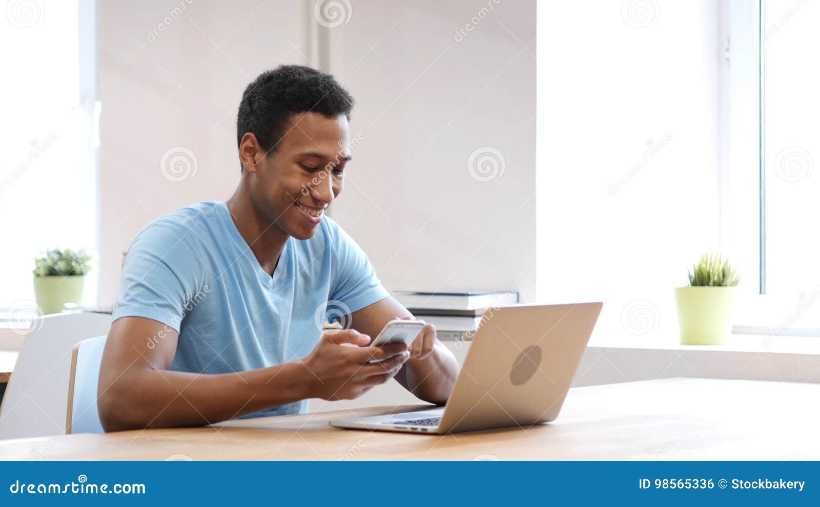 Young Black Man Using Smartphone, Online Browsing Stock Photo - Image ...