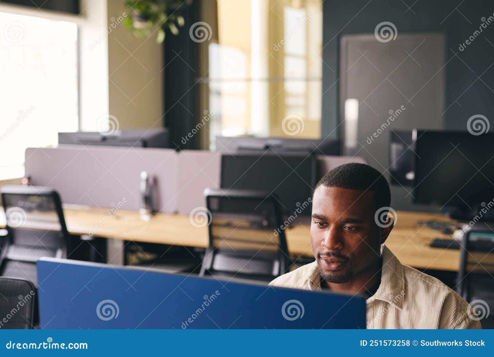 Young Black Man Working on Computer in Modern Office at Desk Stock ...