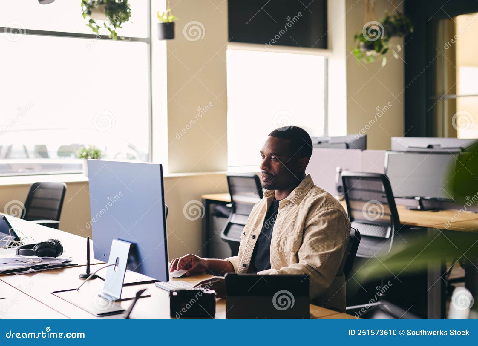 Young Black Man Working on Computer in Modern Office at Desk Stock ...