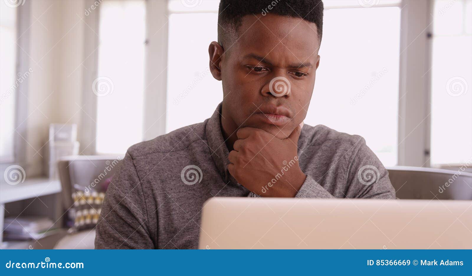 Young Black Man Working on a Laptop from His Home Office Stock Image ...