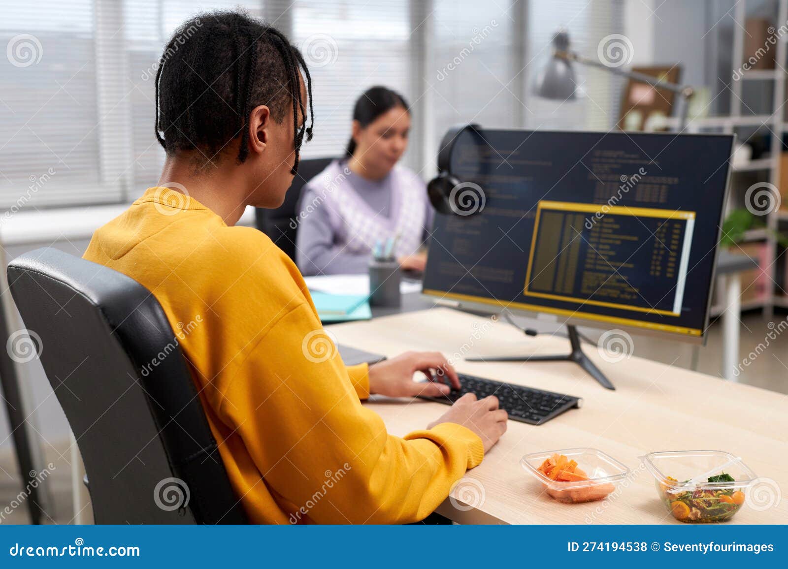 Young Black Man Writing Code while Working at Desk in Office Stock ...
