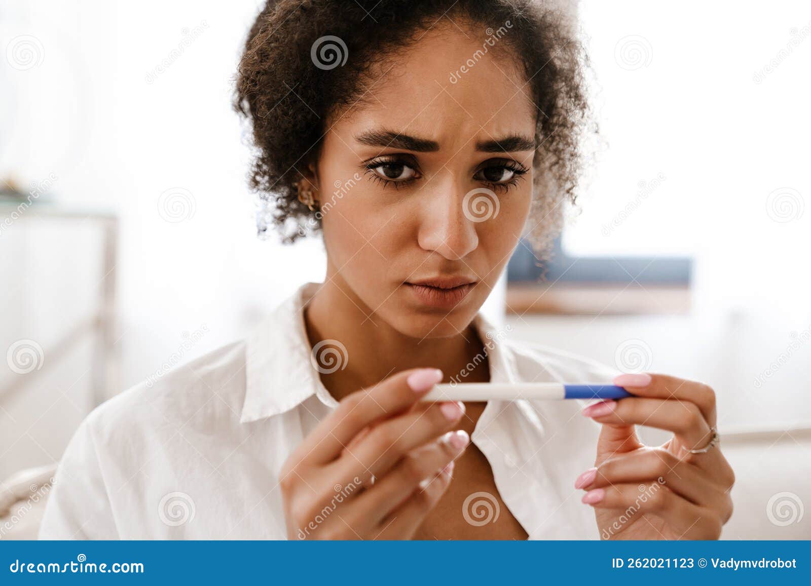 Young Black Woman Being Upset While Holding Pregnancy Test At Home
