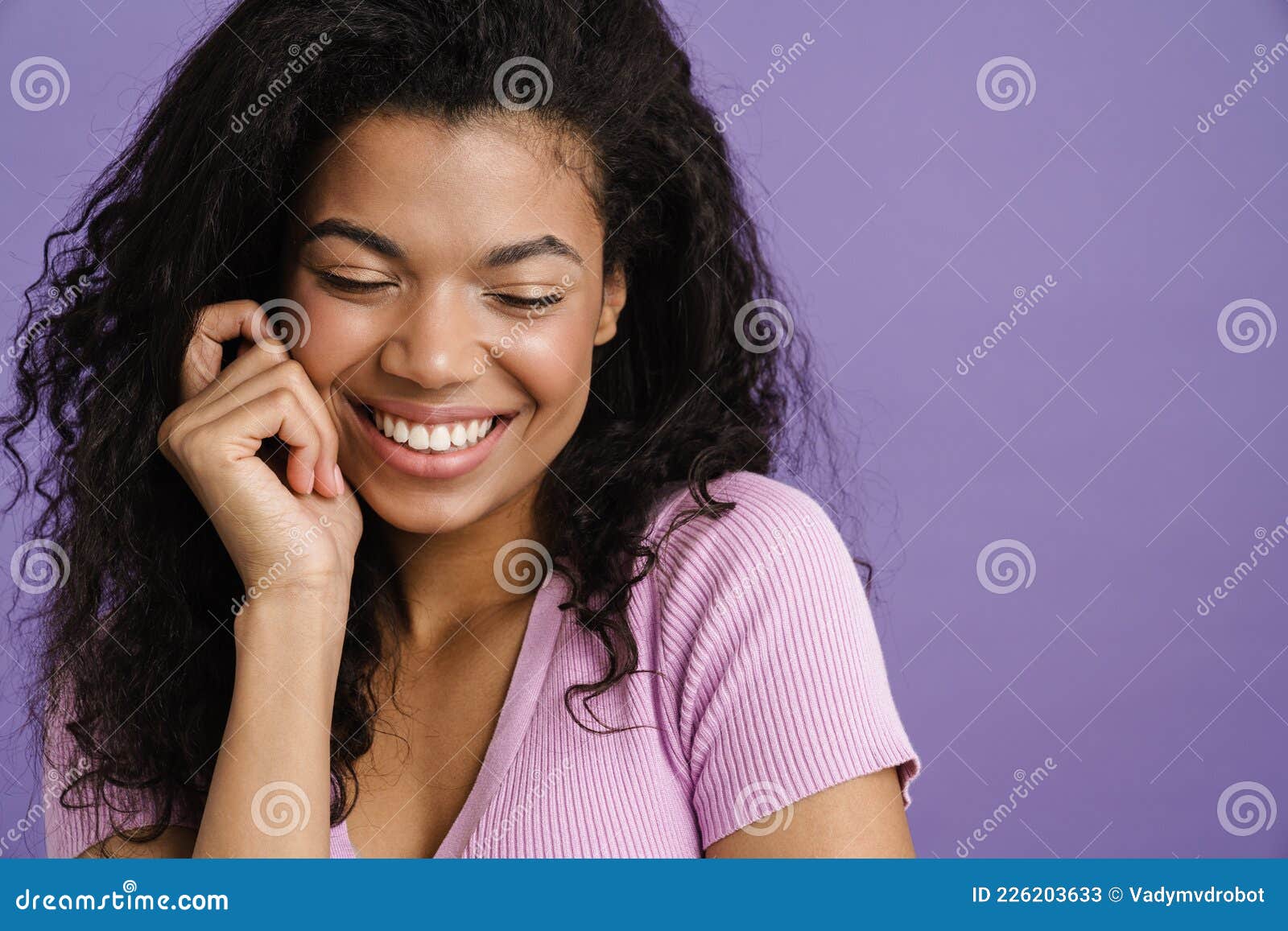Young Black Woman With Curly Hair Posing And Laughing At Camera Stock