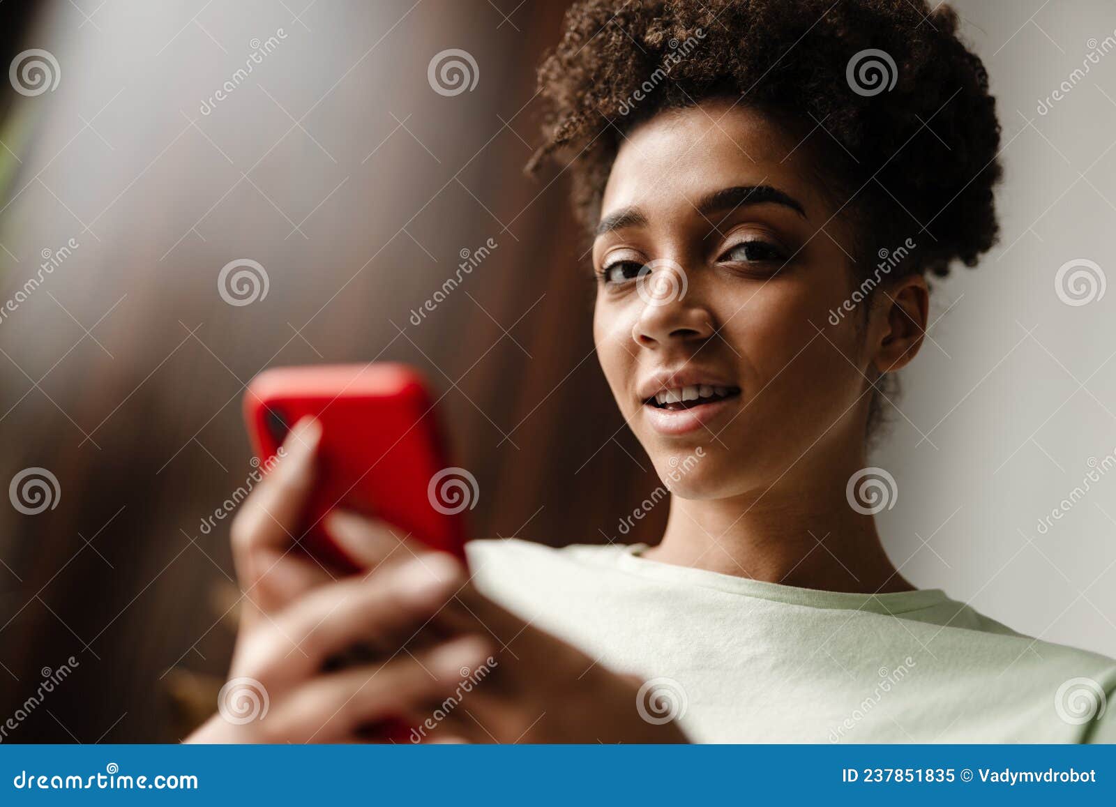 Young Black Woman Using Mobile Phone Standing at Home Stock Image ...