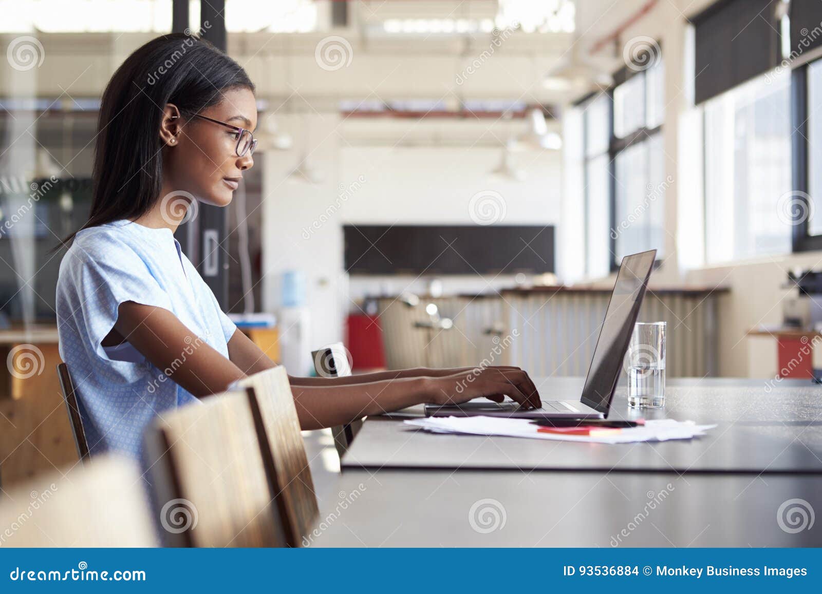 Young Black Woman Working in Office Using a Laptop Computer Stock Photo ...
