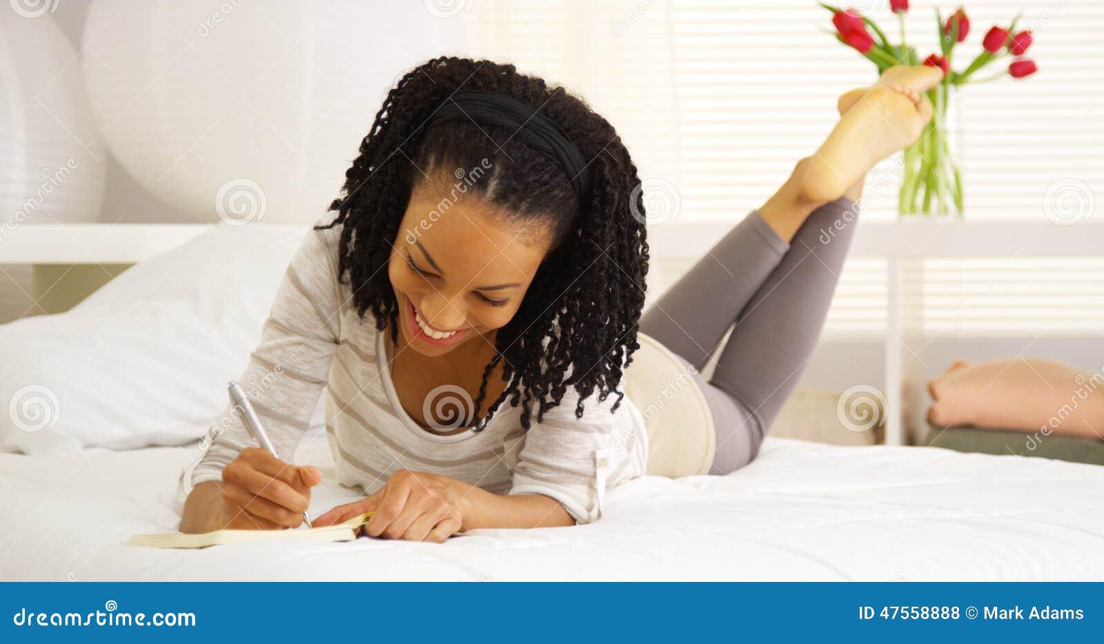 Young Black Woman Writing in Journal Stock Photo - Image of bedroom ...