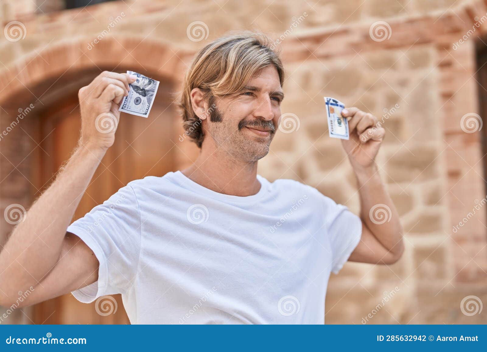 Young Blond Man Breaking 100 Dollars Banknote at Street Stock Photo ...