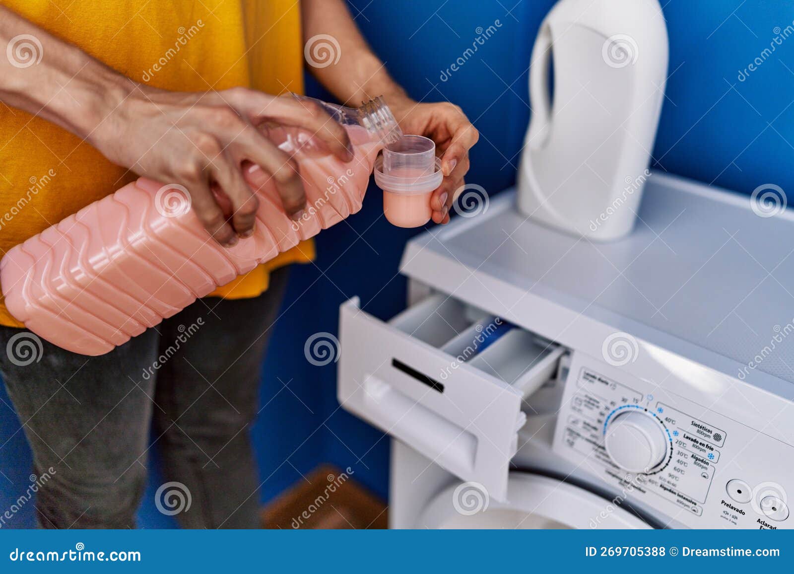 Young Blond Man Pouring Detergent at Laundry Room Stock Photo - Image ...