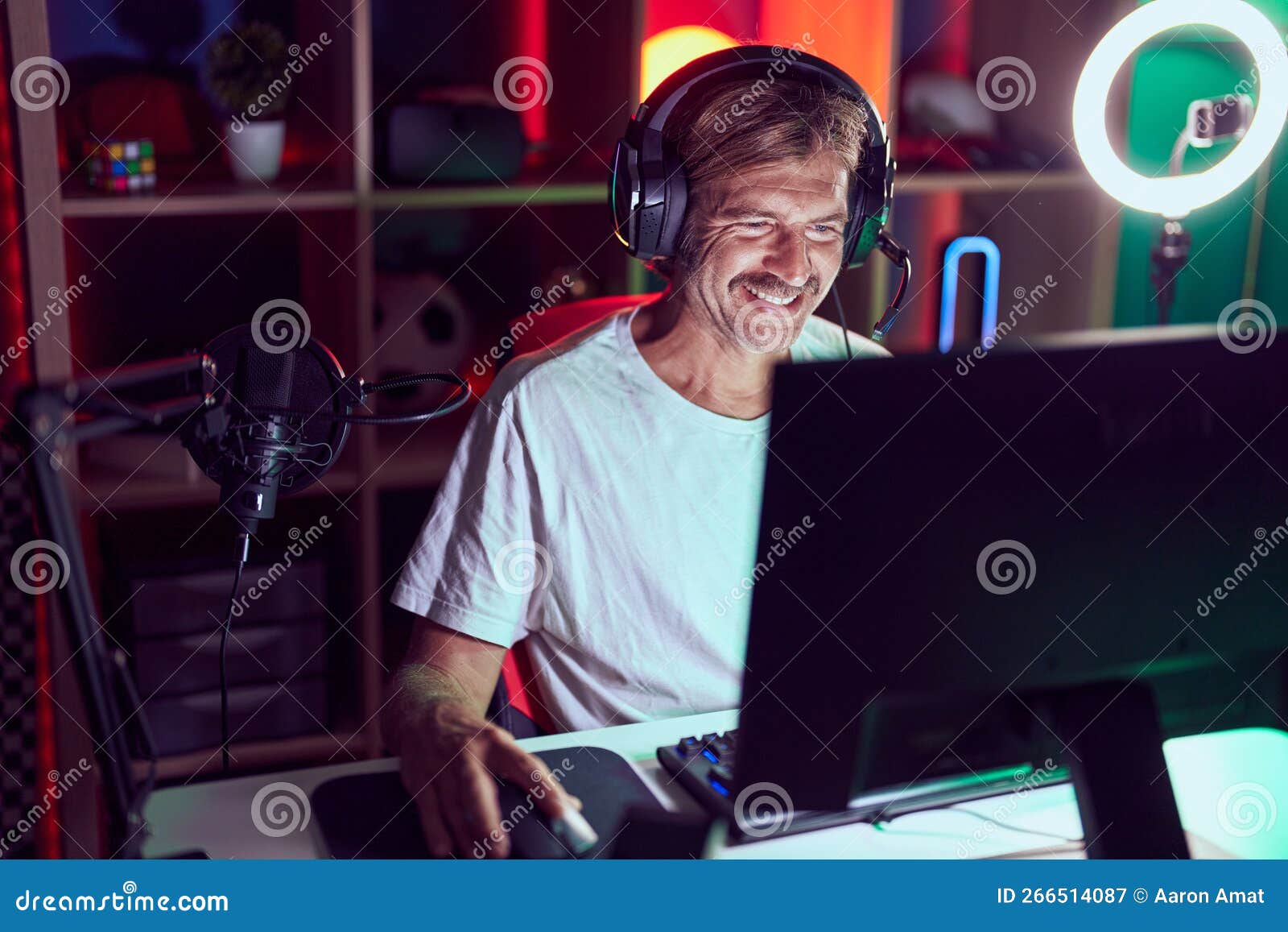 Young Blond Man Streamer Playing Video Game Using Computer at Gaming ...