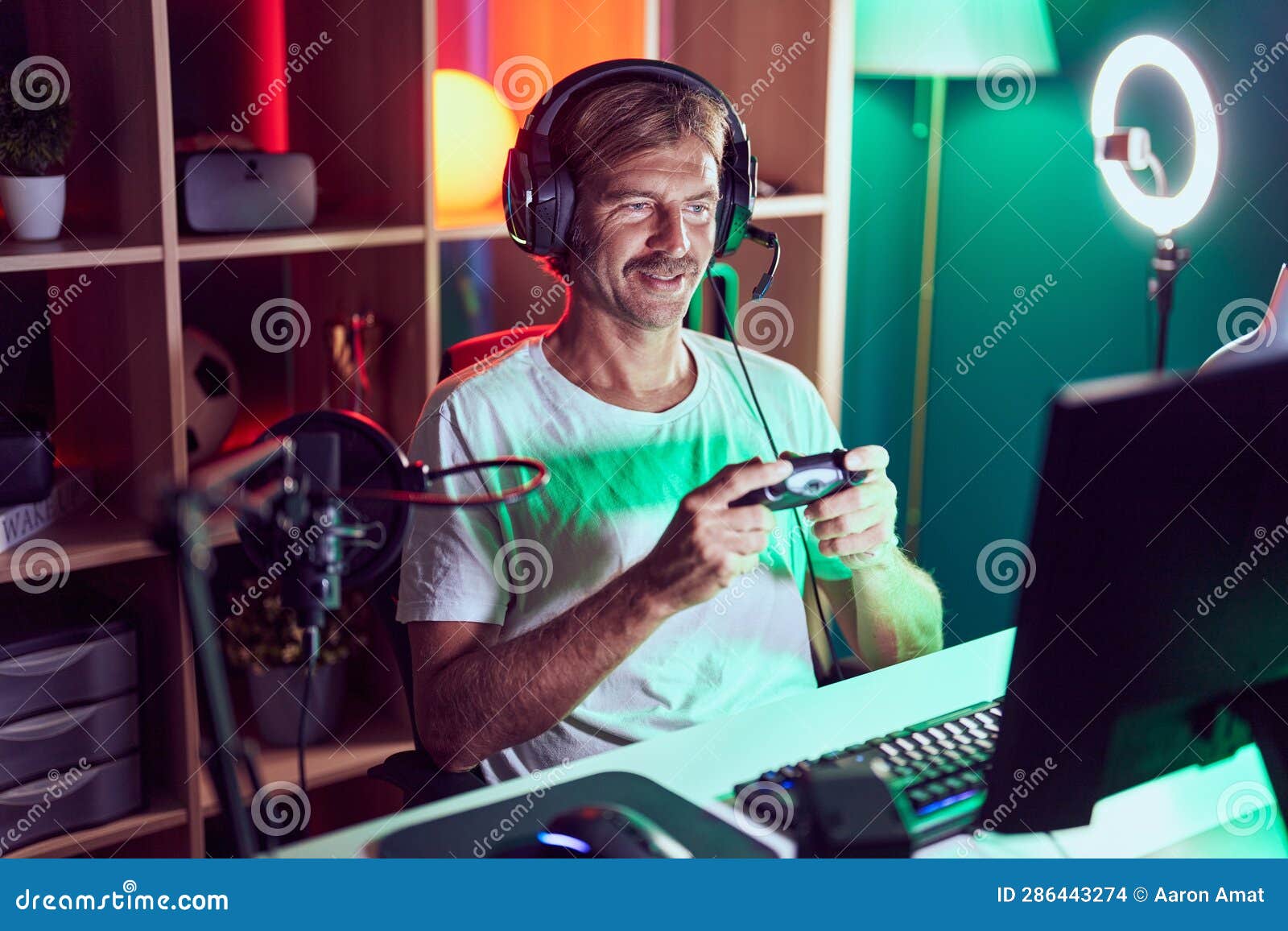 Young Blond Man Streamer Playing Video Game Using Joystick at Gaming ...