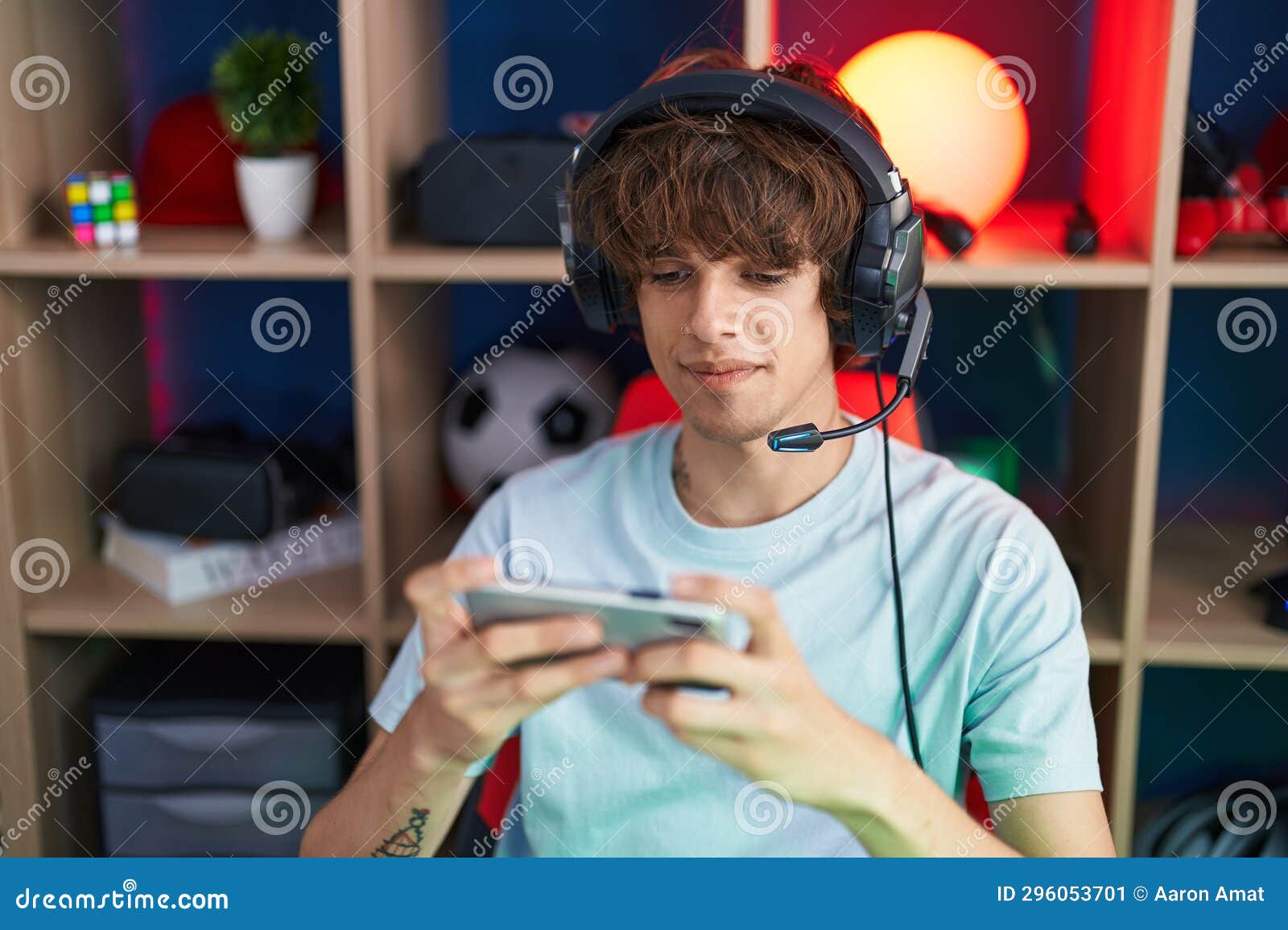 Young Blond Man Streamer Playing Video Game Using Smartphone at Gaming ...