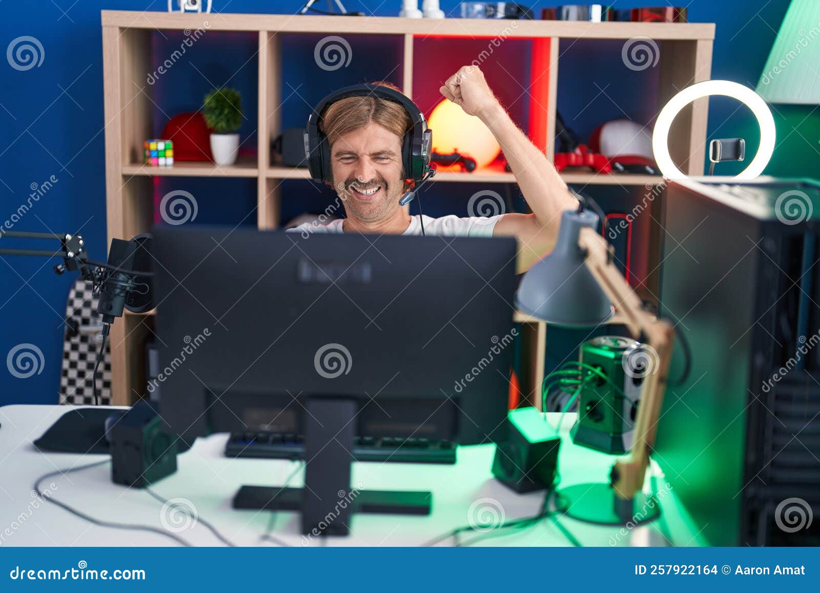 Young Blond Man Streamer Playing Video Game with Winner Expression at ... Young Blond Man Streamer Playing Video Game with Winner Expression at ...