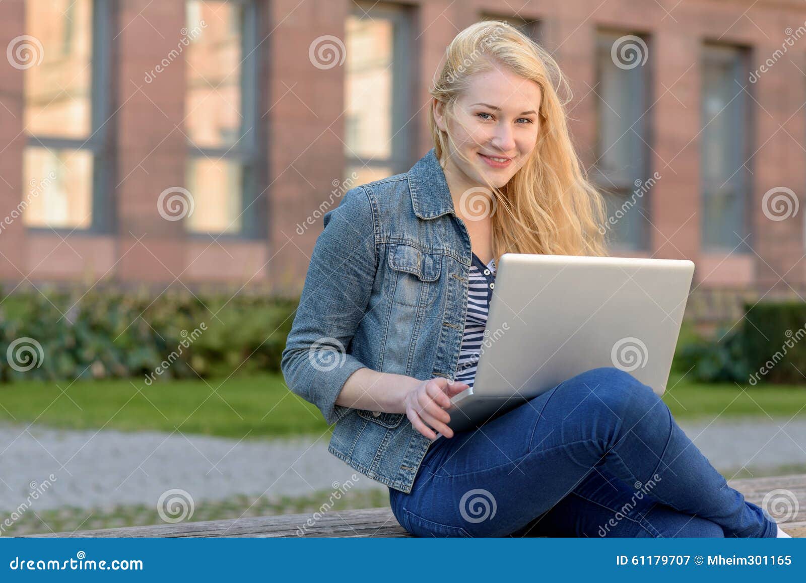 Young Blond Student Sitting on a Bench and Working on Her Laptop Stock ...