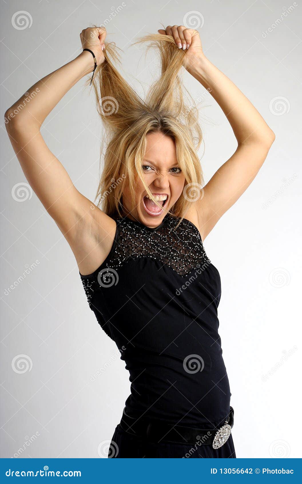 Young blond woman in rage stock photo. Image of female - 13056642