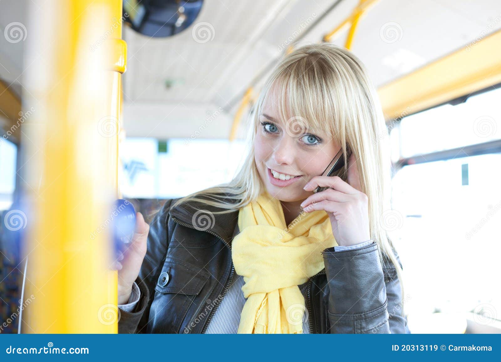 Young Blond Woman with a Smart-phone Inside a Bus Stock Image - Image ...
