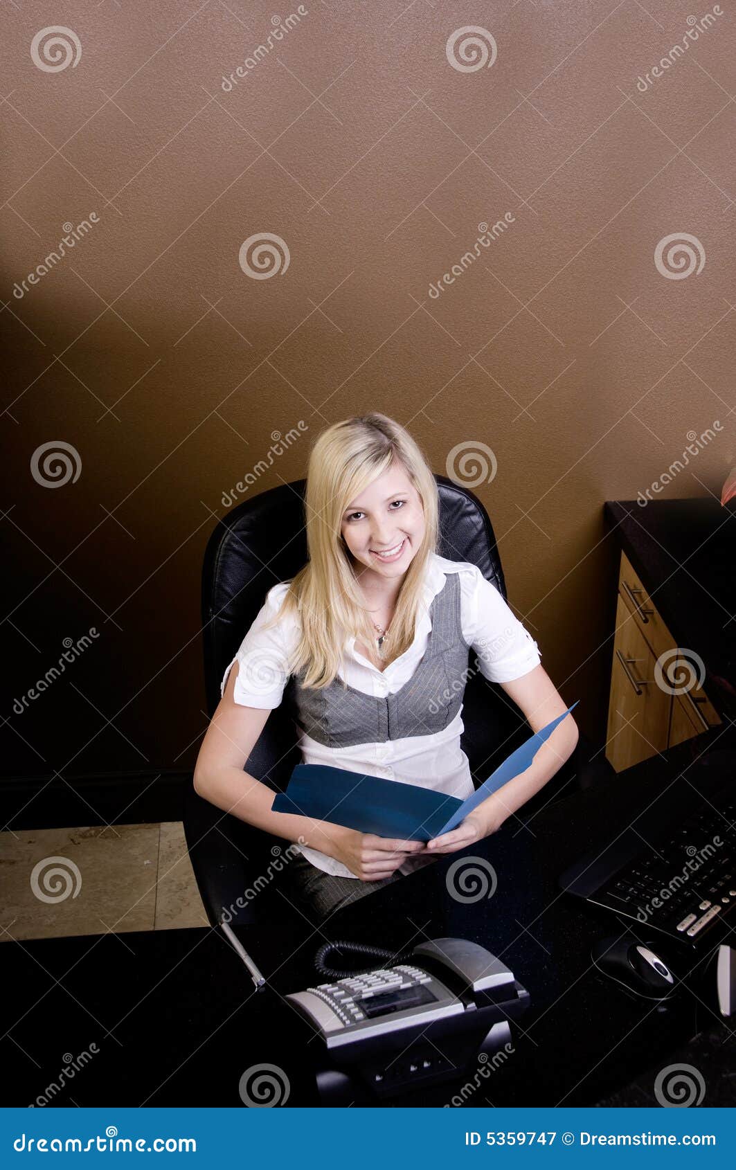 Young Blond Woman Working Behind Desk Stock Image - Image of ...