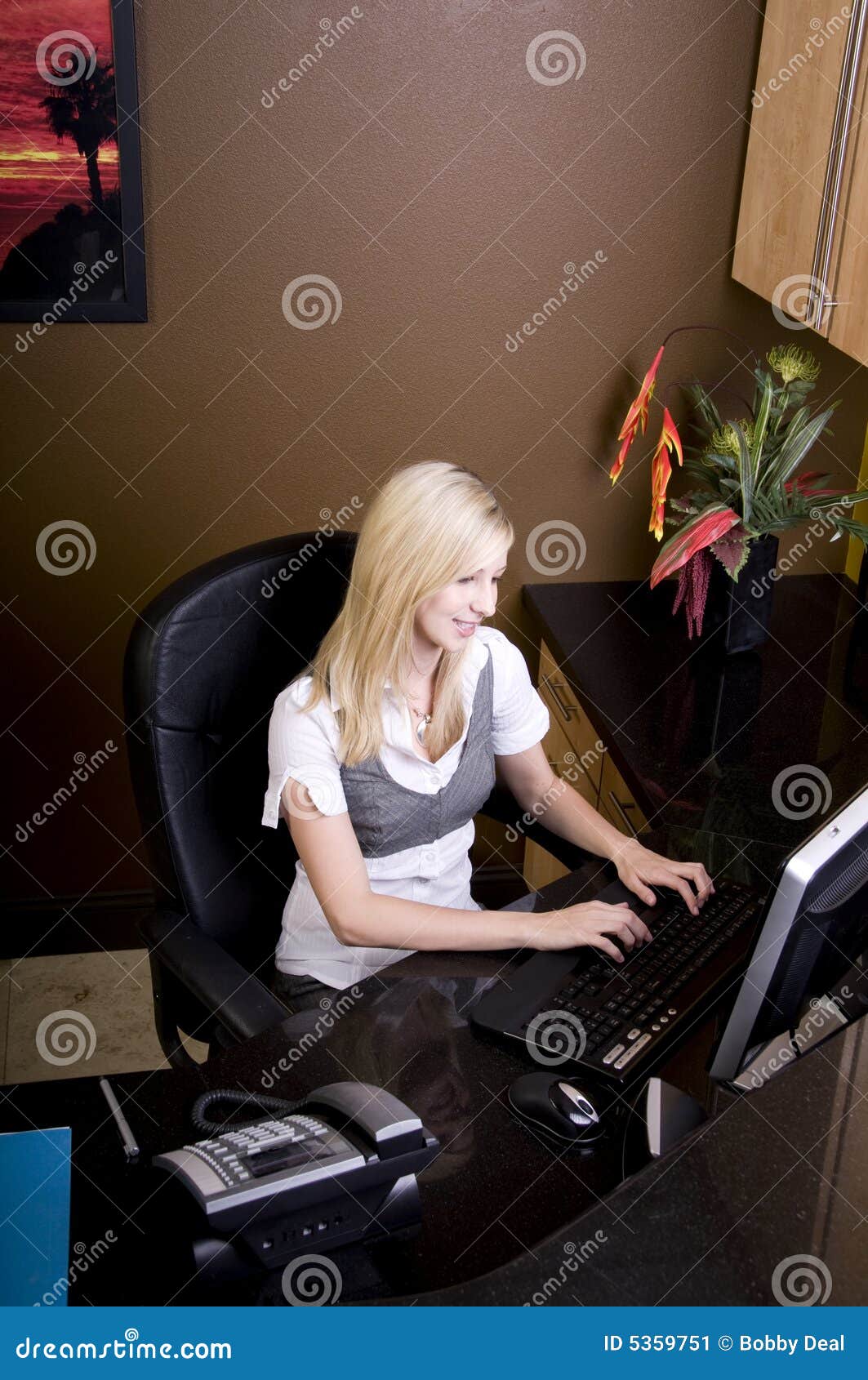 Young Blond Woman Working Behind Desk Stock Image - Image of vest ...