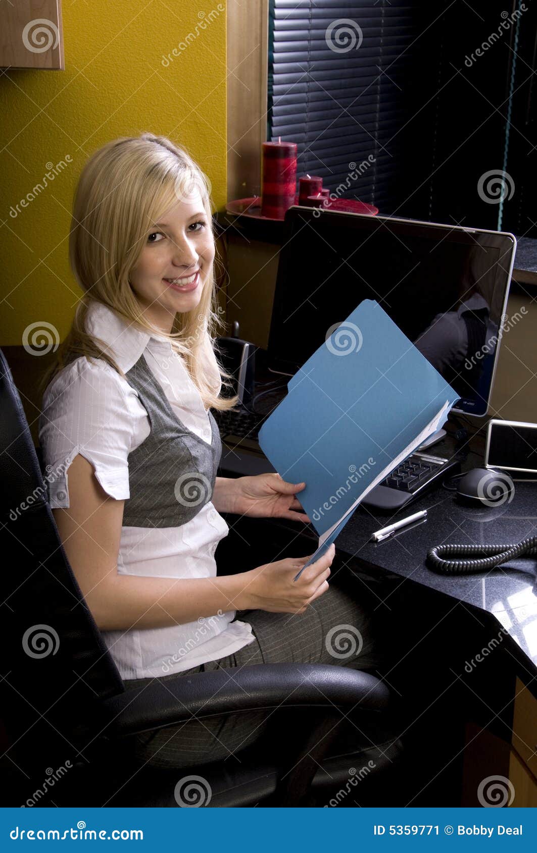 Young Blond Woman Working Behind Desk Stock Image - Image of petite ...