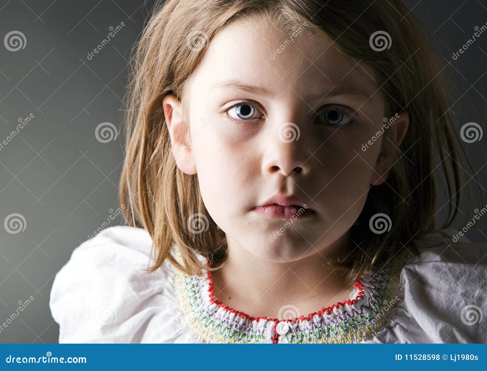 A Young Blonde Child Looks a the Camera in Concern Stock Photo - Image ...