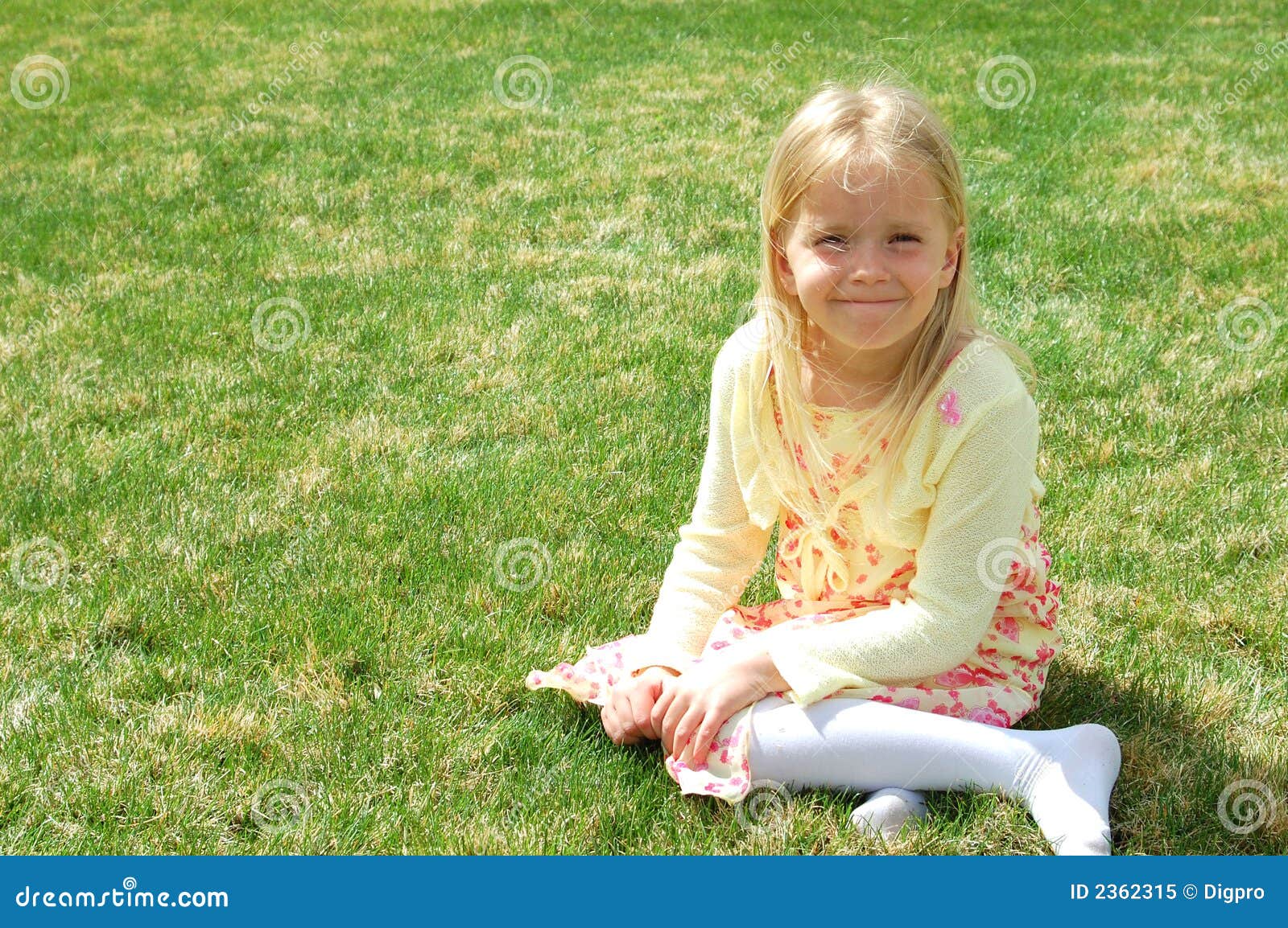 Young blonde girl on grass stock image. Image of hand - 2362315