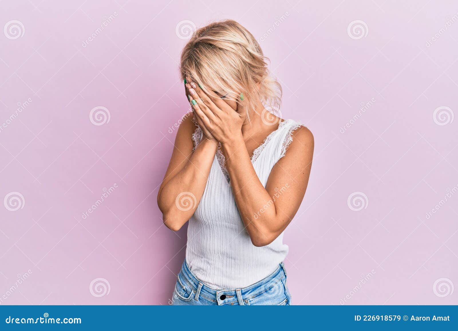 Young Blonde Girl Wearing Casual Clothes With Sad Expression Covering