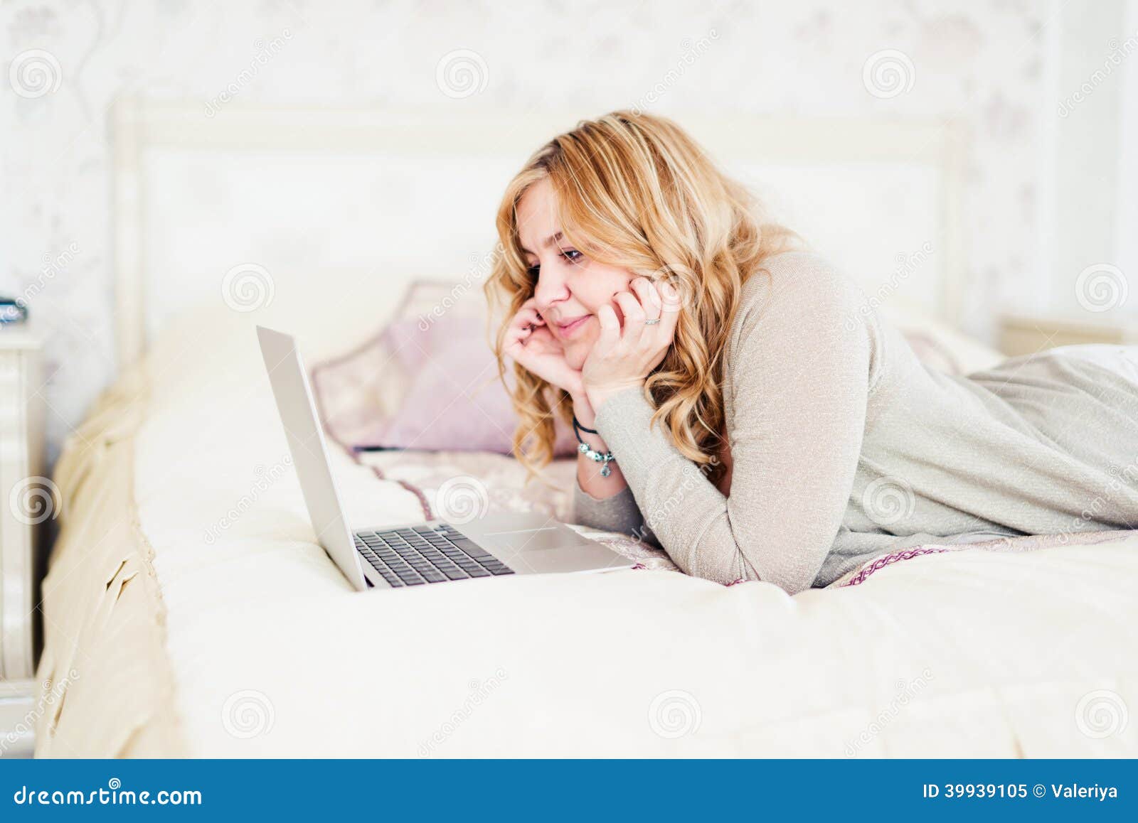 Young Blonde Lying on Her Bed Using Laptop Stock Image - Image of ...