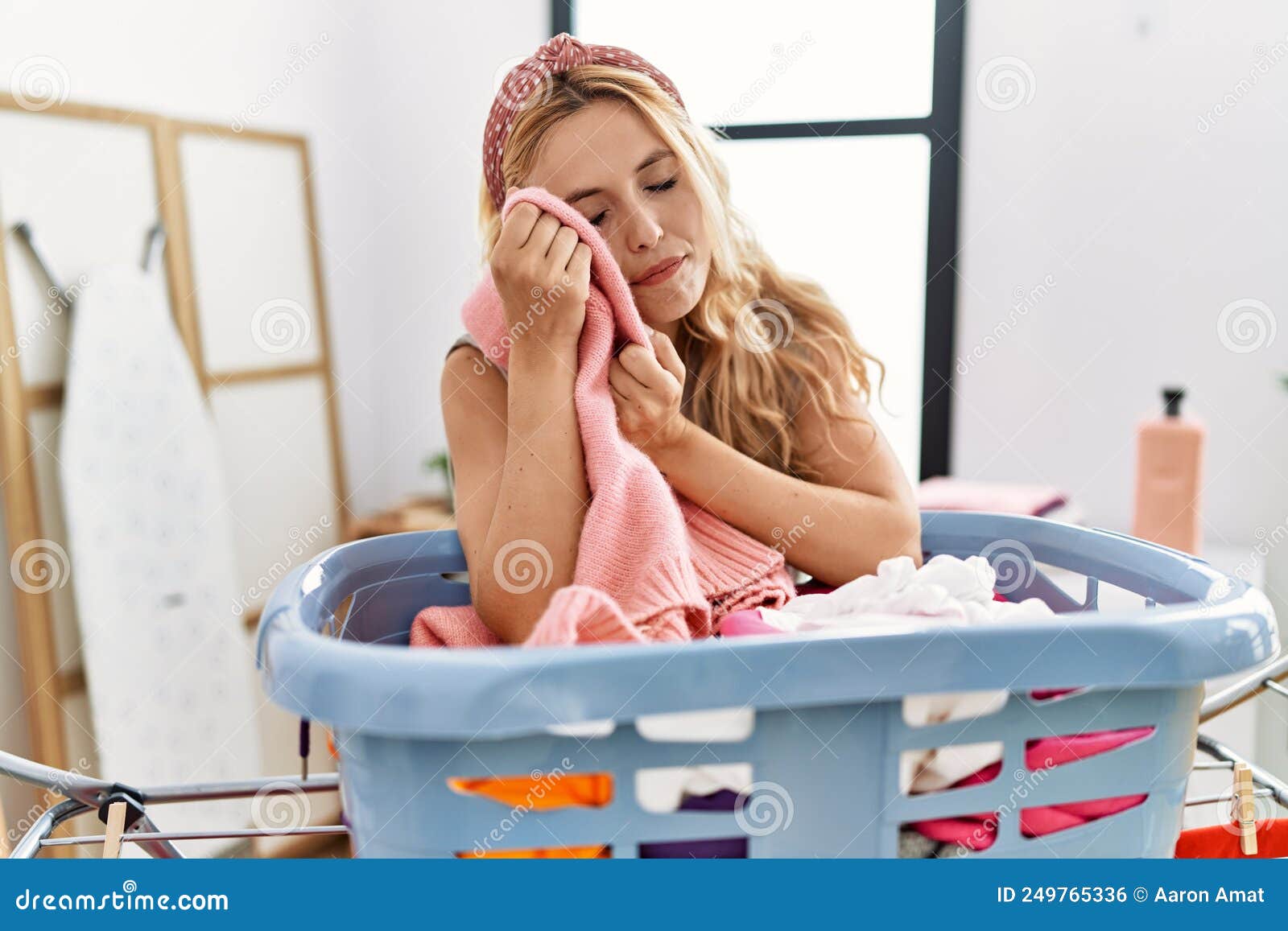Young Blonde Woman Doing Laundry at Laundry Room Stock Photo - Image of ...