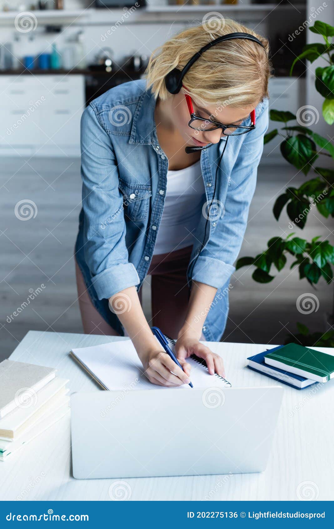 Blonde Woman in Eyeglasses Writing Notes Stock Photo - Image of jeans ...