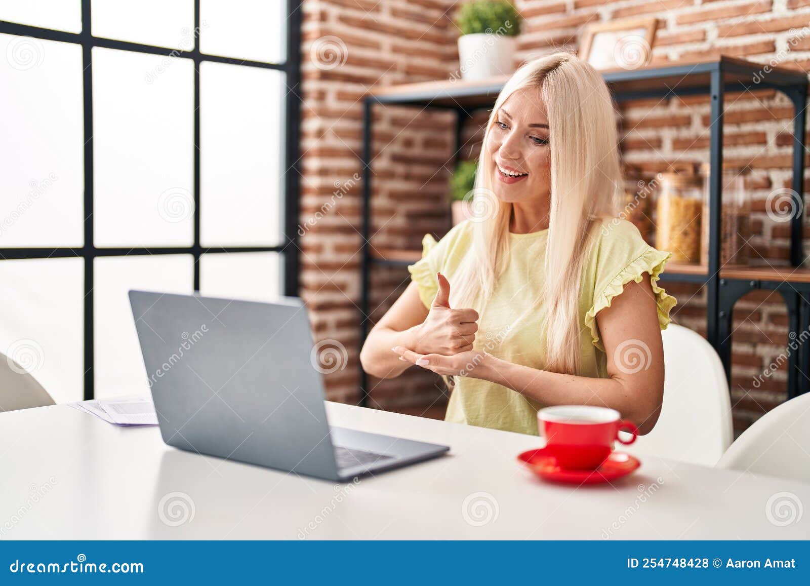 Young Blonde Woman Having Video Call Using Deaf Language at Home Stock ...